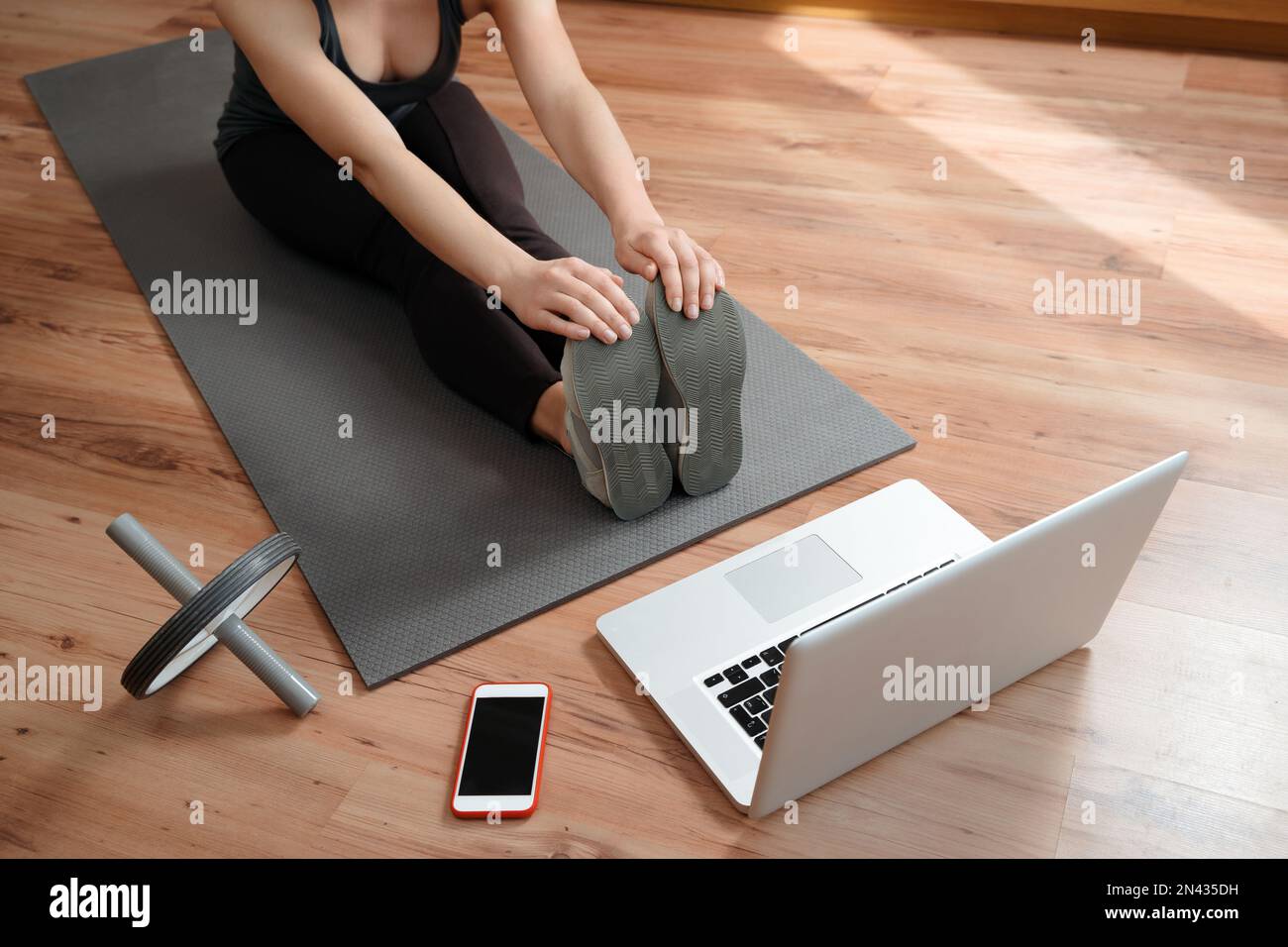 Fitness coach teaching yoga online. Workout trainer demonstrating ...