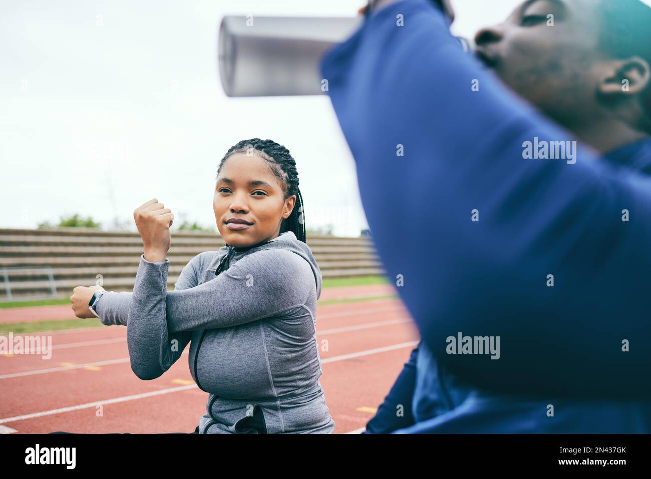 Running, sports and black woman stretching on race track for exercise ...