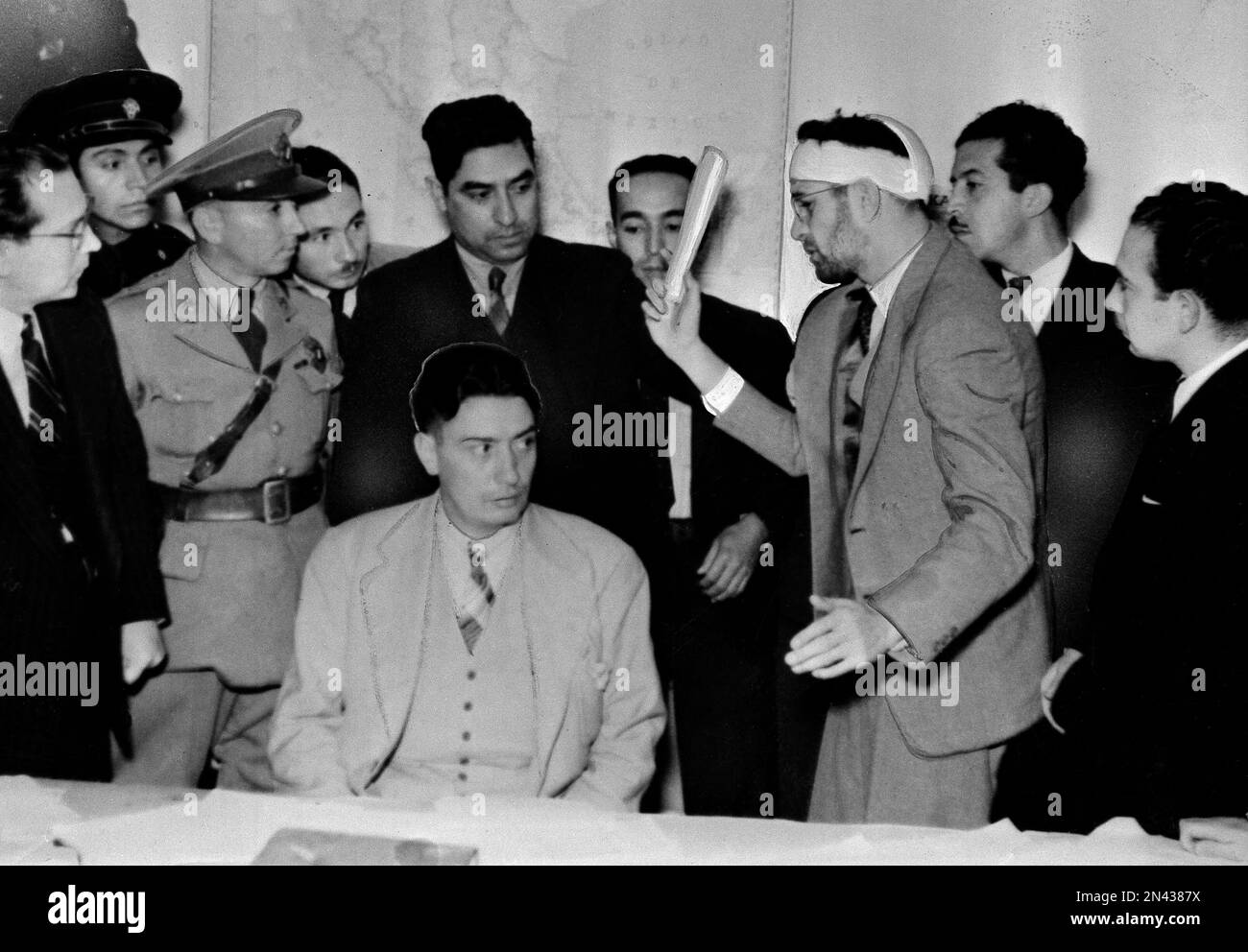 Ramon Mercader, head bandaged, reenacts for Mexican police his pickax ...