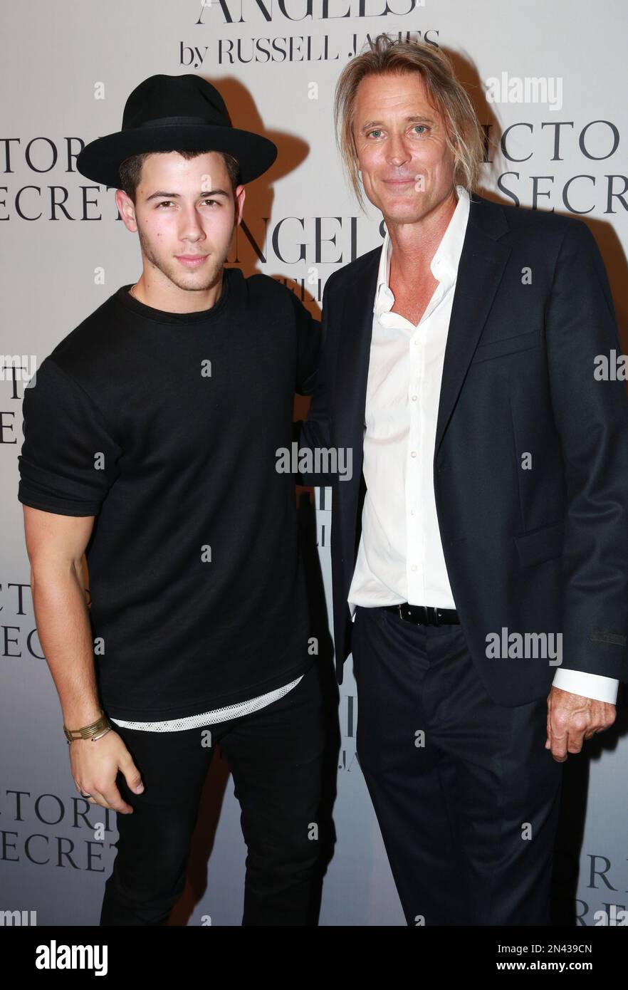 Nick Jonas and photographer Russell James arrive at a gallery ...
