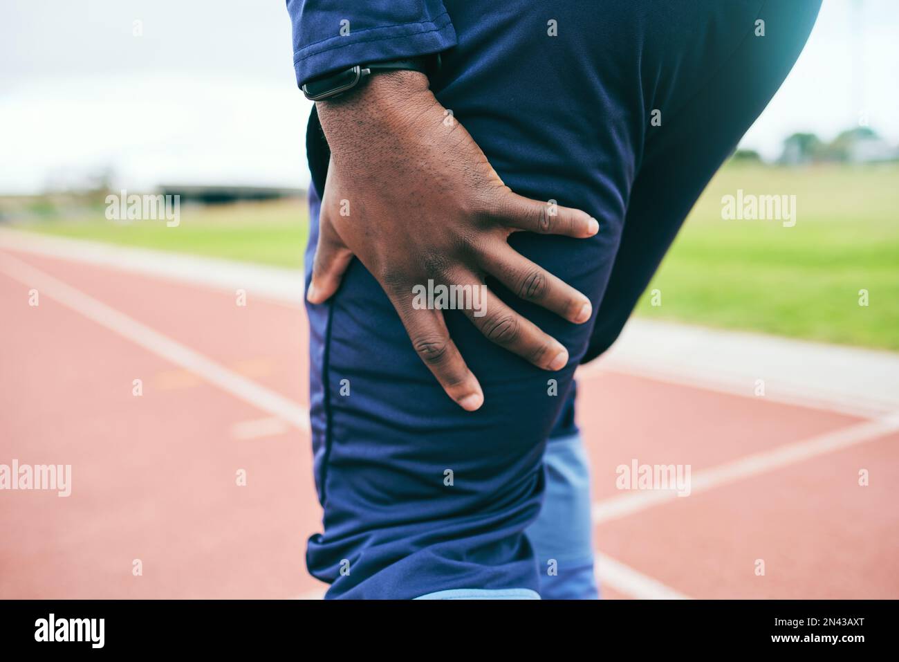 Leg pain, injury and black man runner, fitness and race in stadium ...