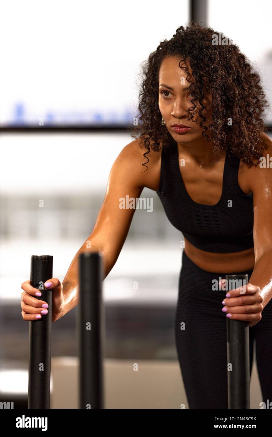 African American fitness trainer pulls a crossfit sled from the ...