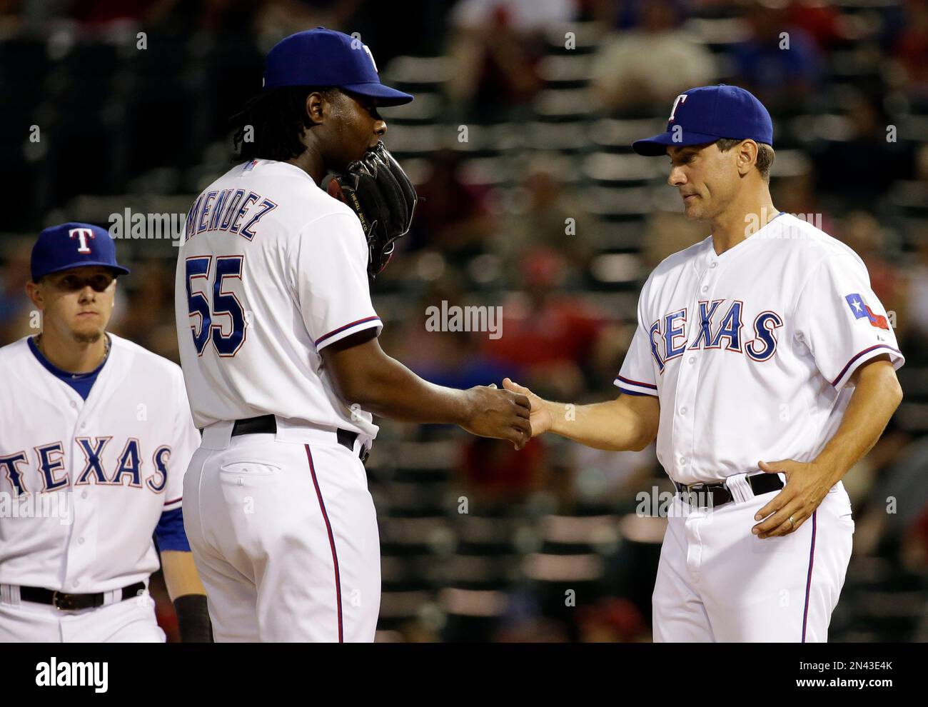 Texas Rangers relief pitcher Roman Mendez (55) turns the ball over to ...