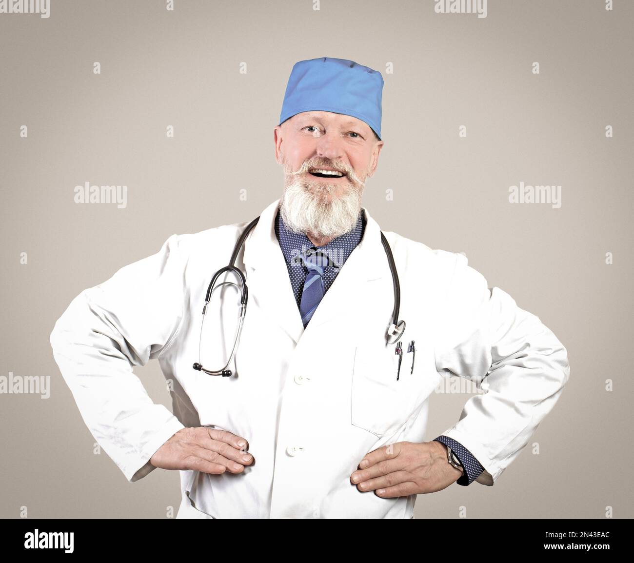 Portrait of an elderly positive doctor with a stethoscope on a gray ...