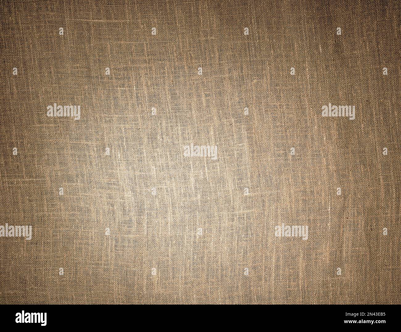 Abstract background with a gradient of rough fabric, backlit by a ...