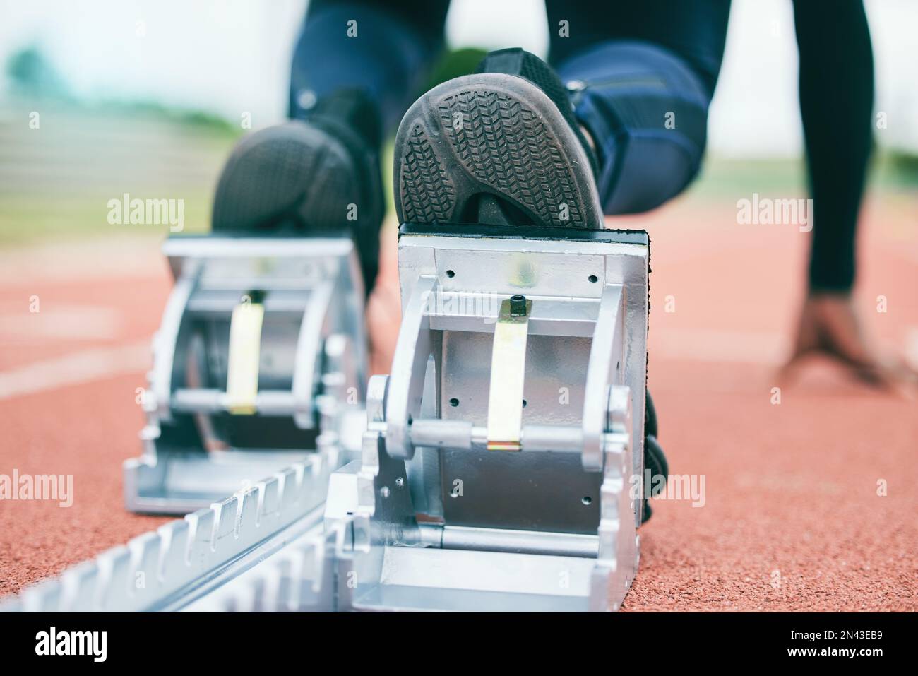 Race track, start blocks and running with athlete feet, run in stadium ...