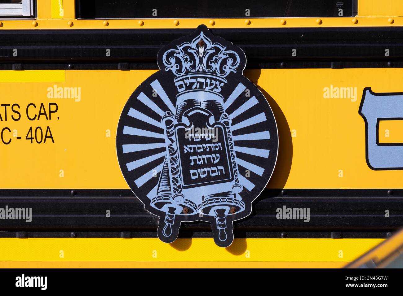 A school bus with a logo of the Tzehelm Hasidic group. Parked in ...