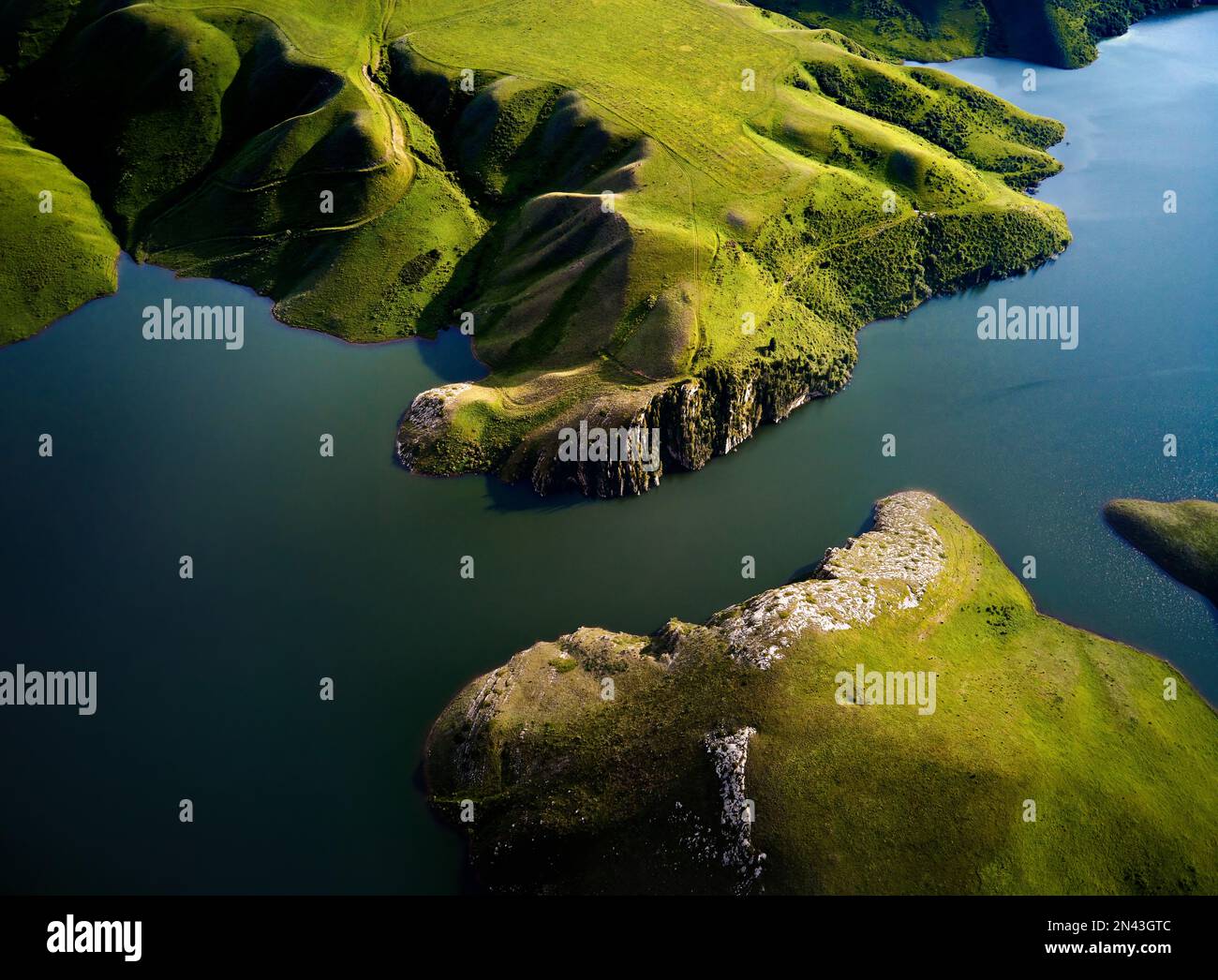 Aerial drone shot of beautiful scenery of blue mountain lake with green ...