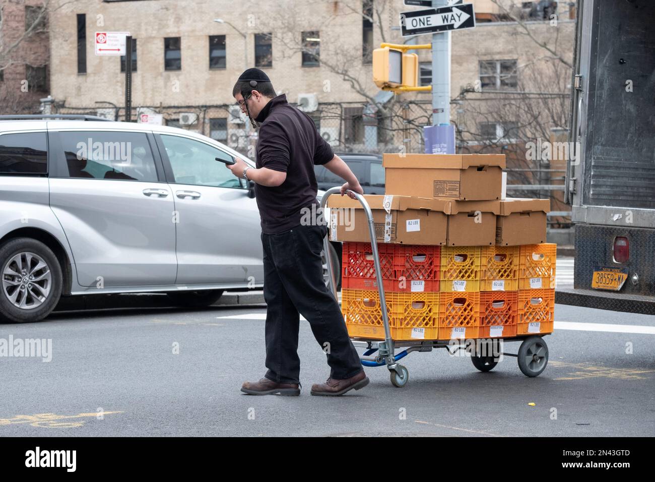 A worker for Satmar Meat delivers crates & cartons from the warehouse ...