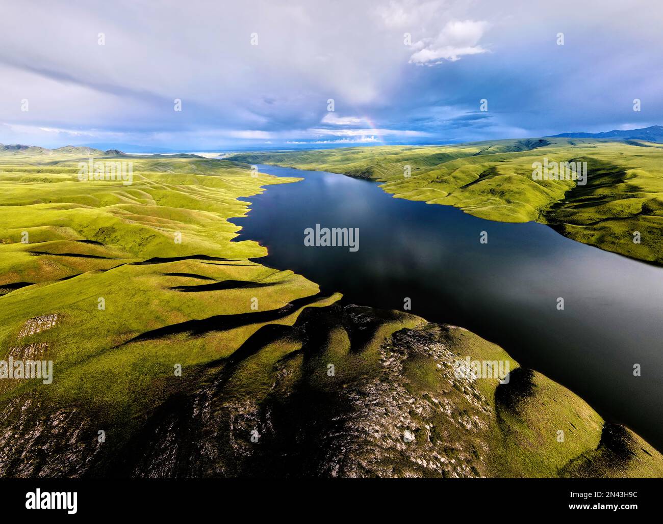 Aerial drone shot of beautiful scenery of blue mountain lake with green ...