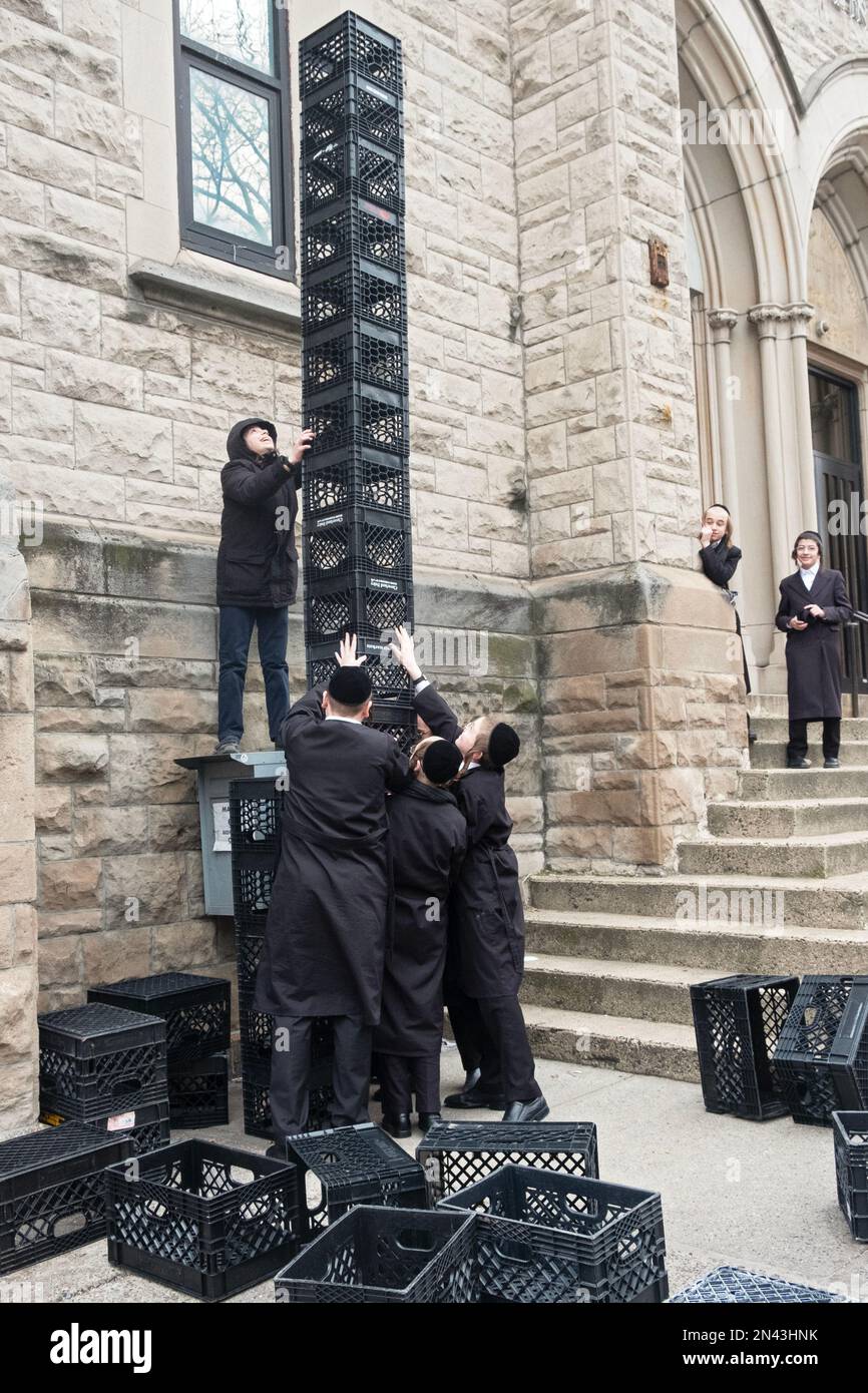 Ultra orthodox Jewish yeshiva students at an urban school build a tower ...