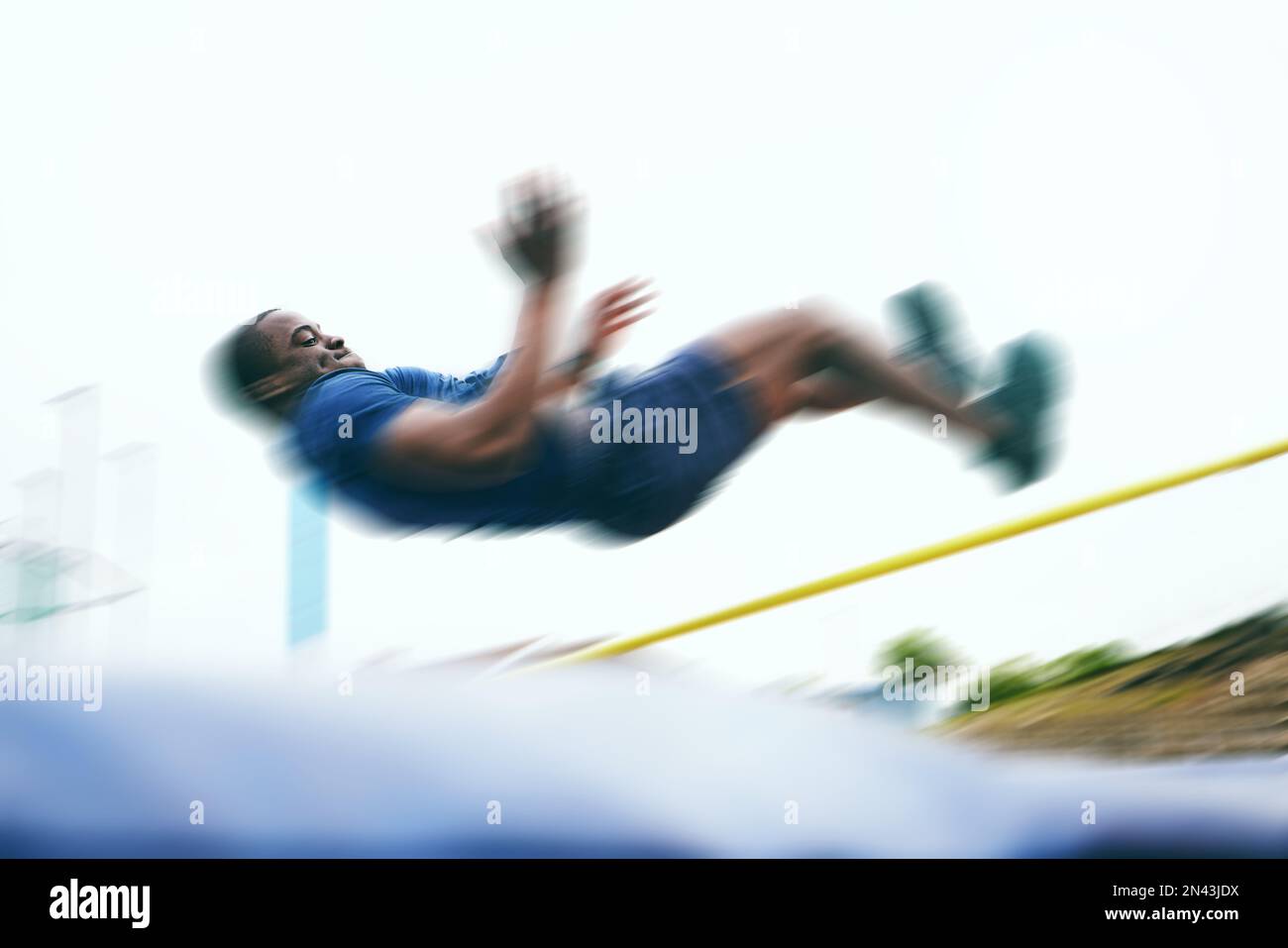 Athletics, fitness and high jump by man at a stadium for training ...