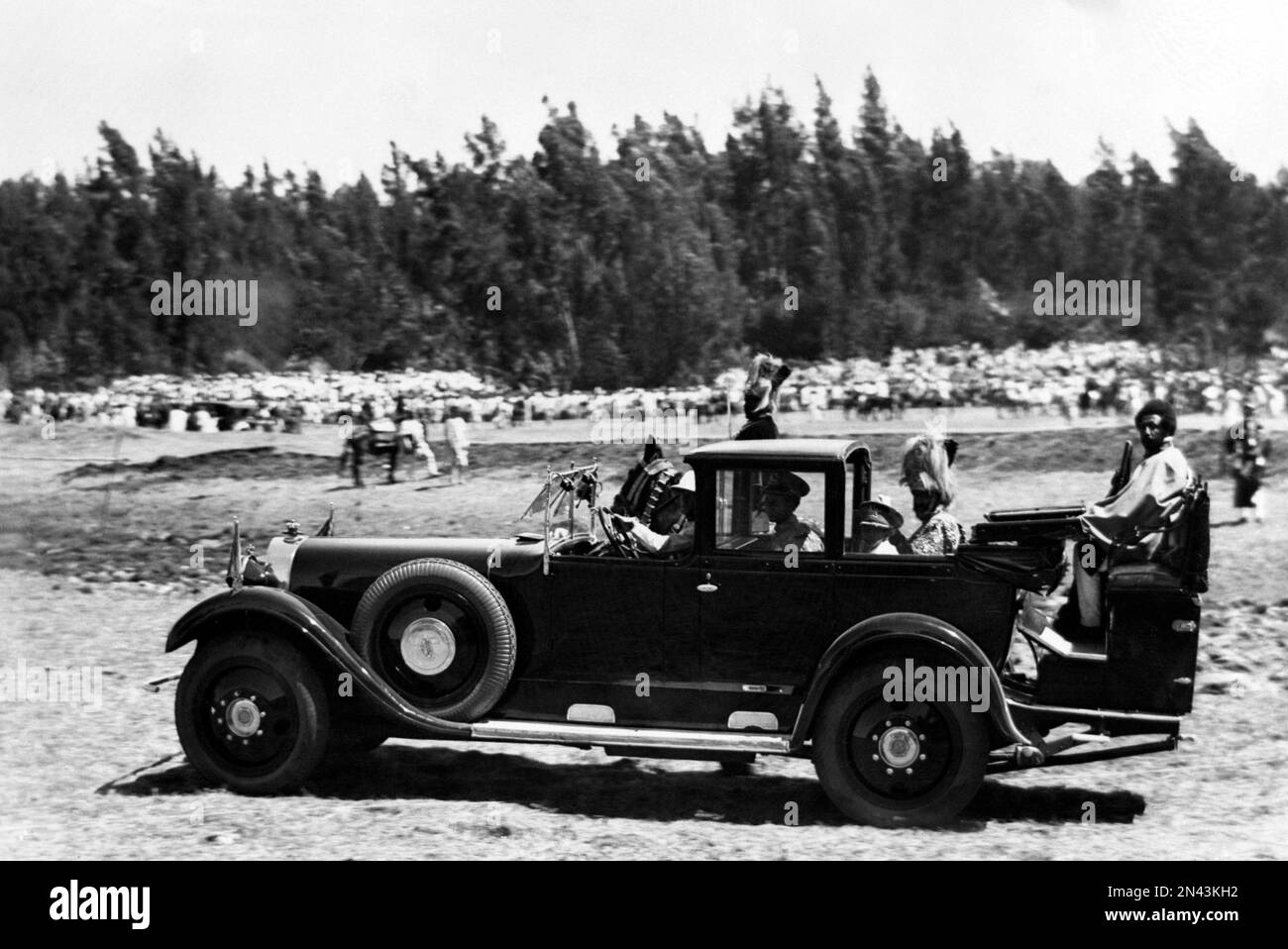 Emperor Haile Selassie, in plumed hat, riding to a review in his car in ...
