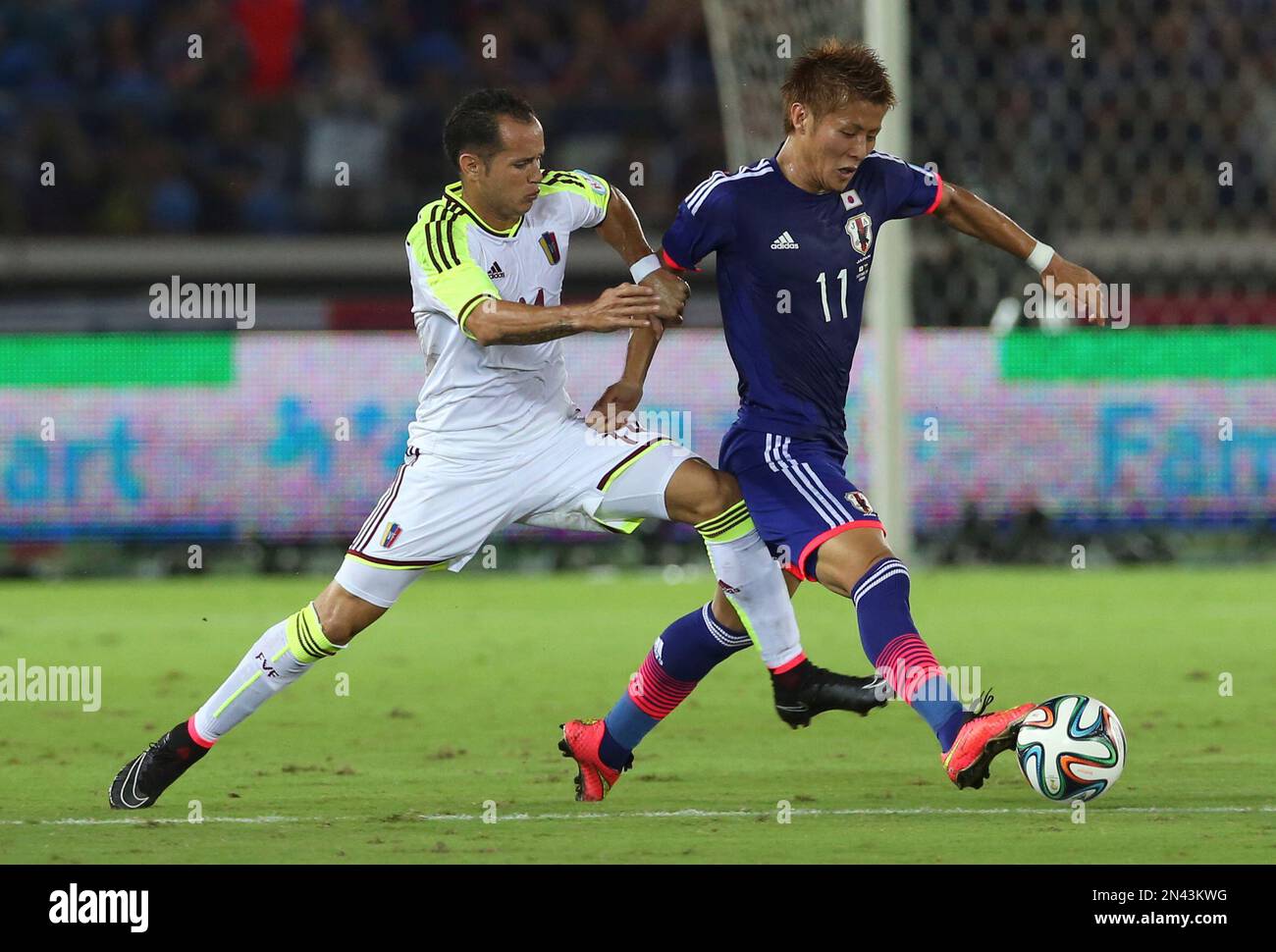 Japan’s Yoichiro Kakitani, right, and Venezuela’s Alejandro Guerra ...