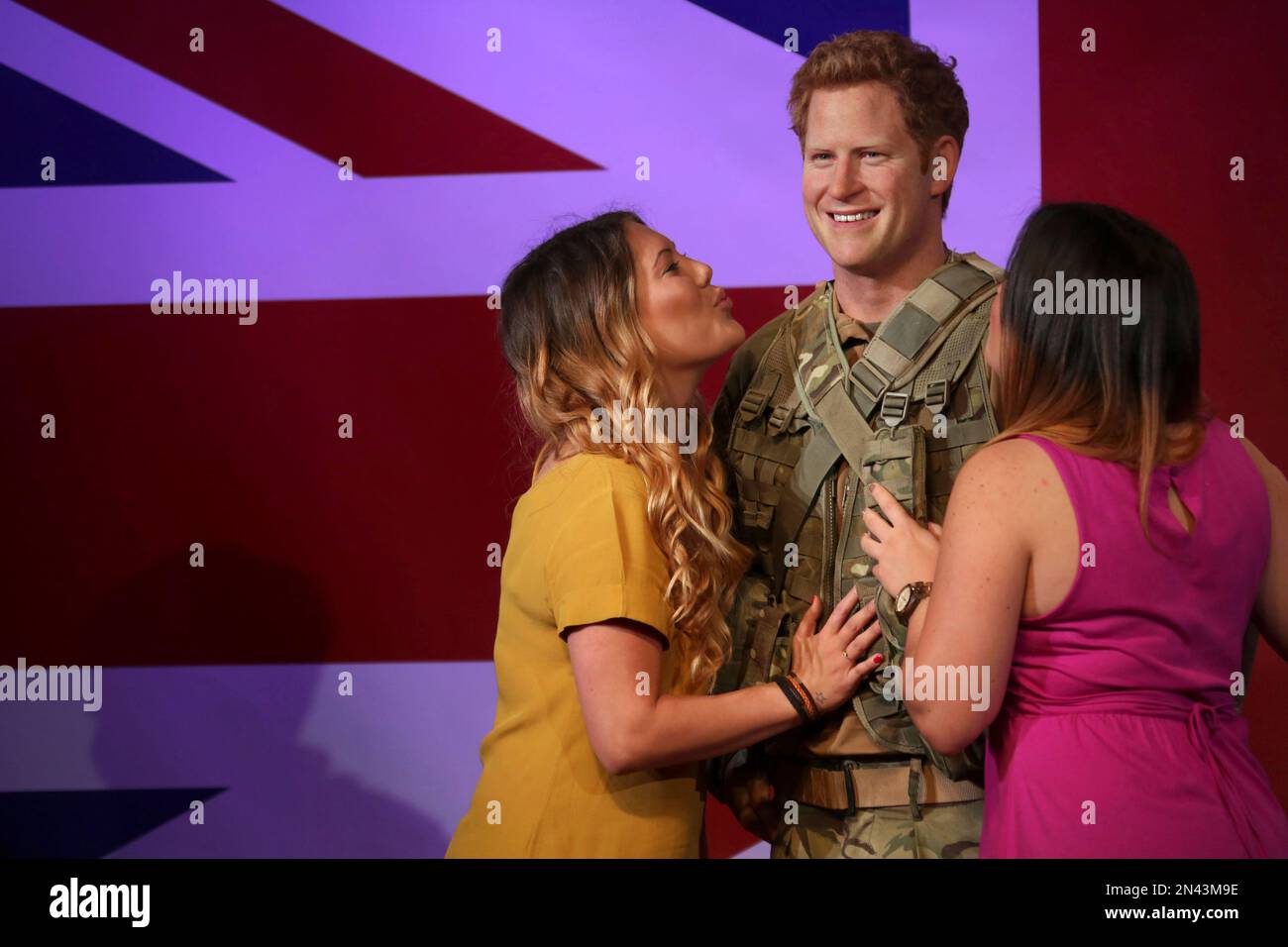 Fans Helen Smith, left, and Lucy Jenner blow a kiss at a new wax figure ...