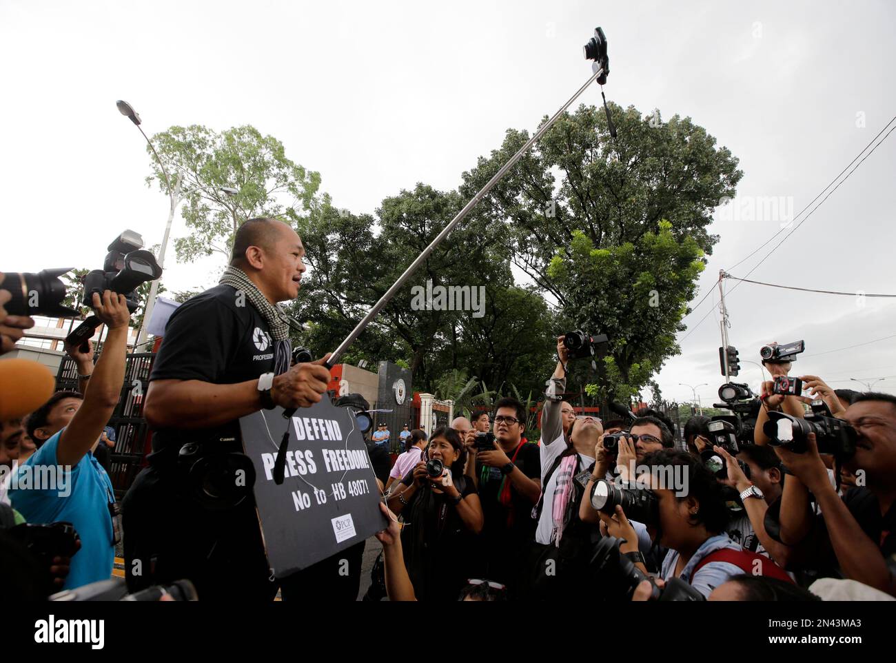 Filipino photojournalist Michelle Alquinto holds a selfie camera as he ...