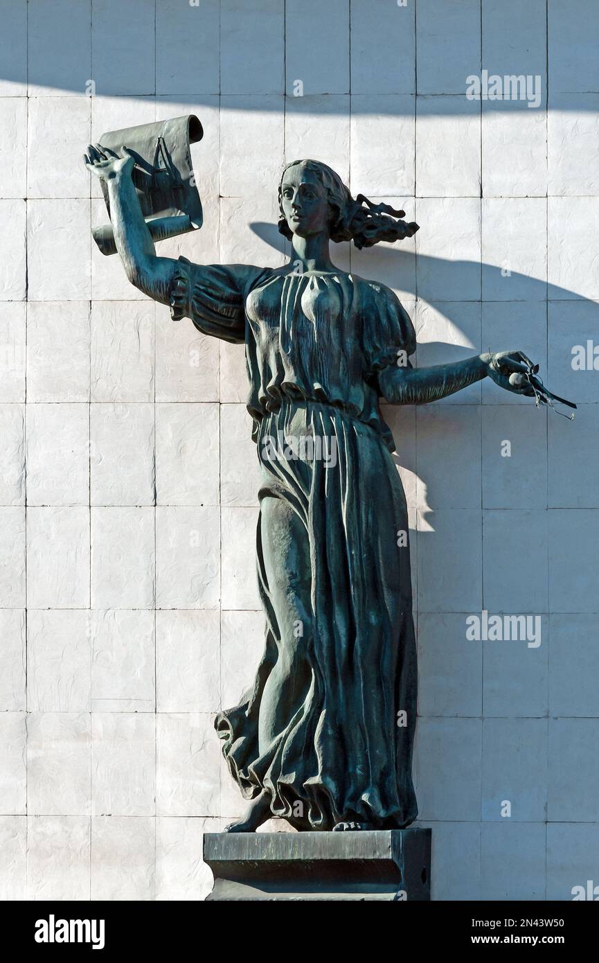 Allegoric woman sculpture with scroll on the old building facade of The ...