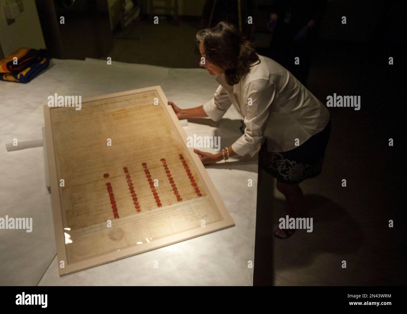 Terry Boone, Exhibits Conservator from the National Archives prepares ...