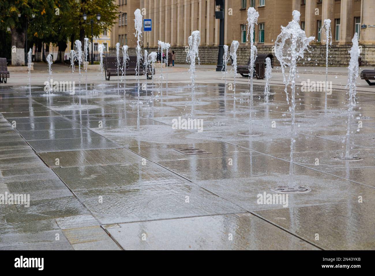Slow splashes of a modern fountain spouting from underground Stock ...
