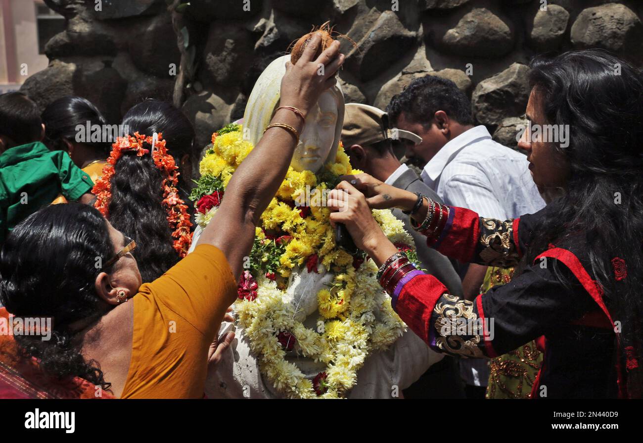 Indian Catholics offer prayers in front of a statue of the Virgin Mary ...