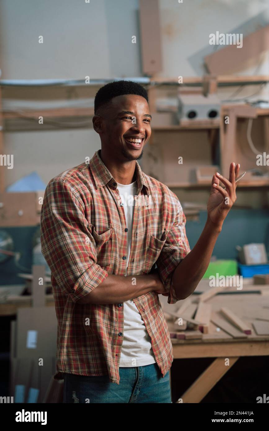 Confident smiling young African male trainee in factory Stock Photo - Alamy