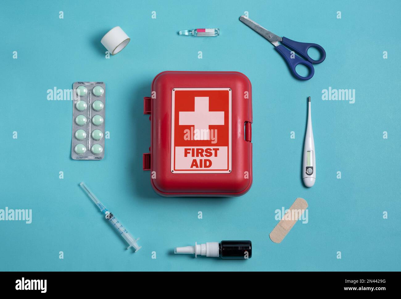 Home first aid kit on a blue background. The elements of the first aid ...