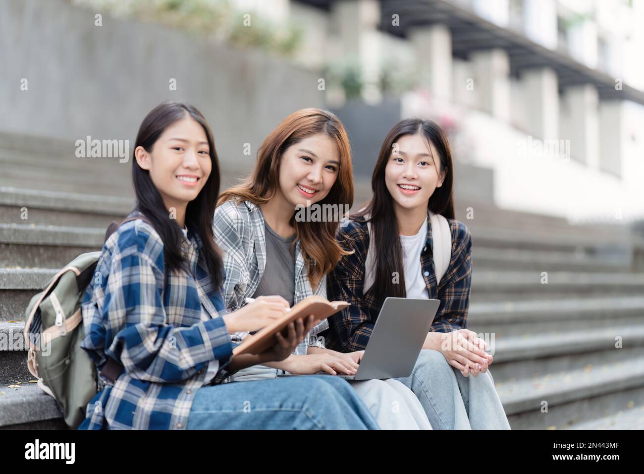 Beautiful young Asian woman college student with friends at outdoors ...