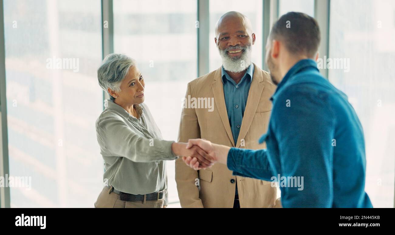 Handshake, welcome and thank you with business people in office after ...
