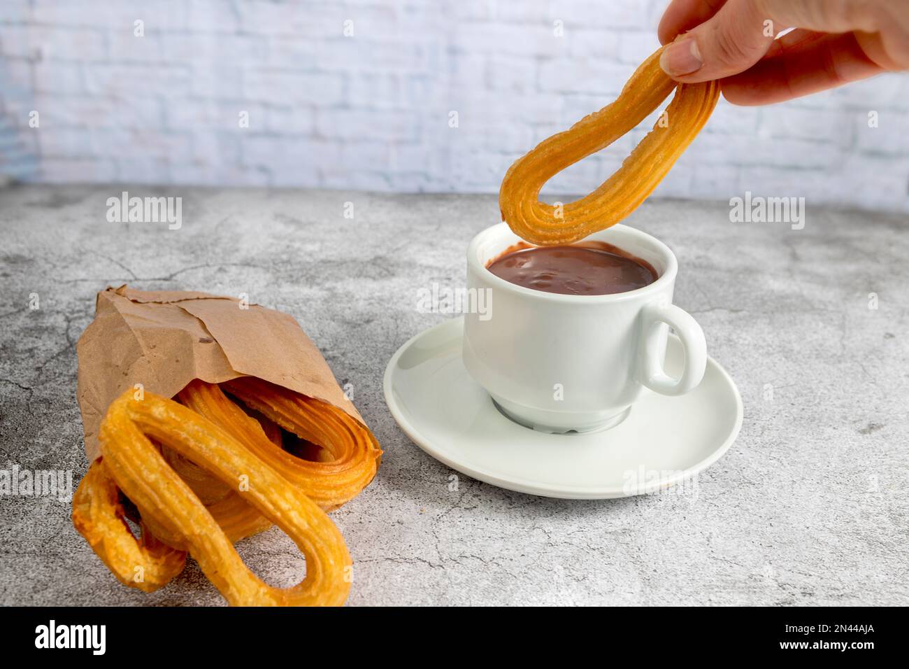 Churros in paper bag with cup of hot chocolate, typical spanish ...