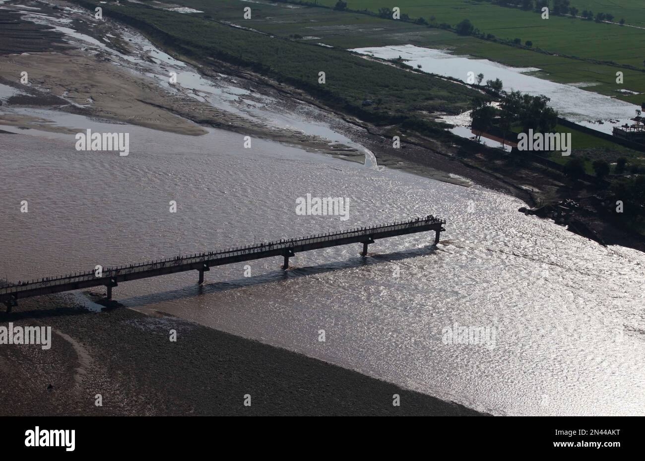 An aerial view of a bridge across the Tawi River that was damaged in ...