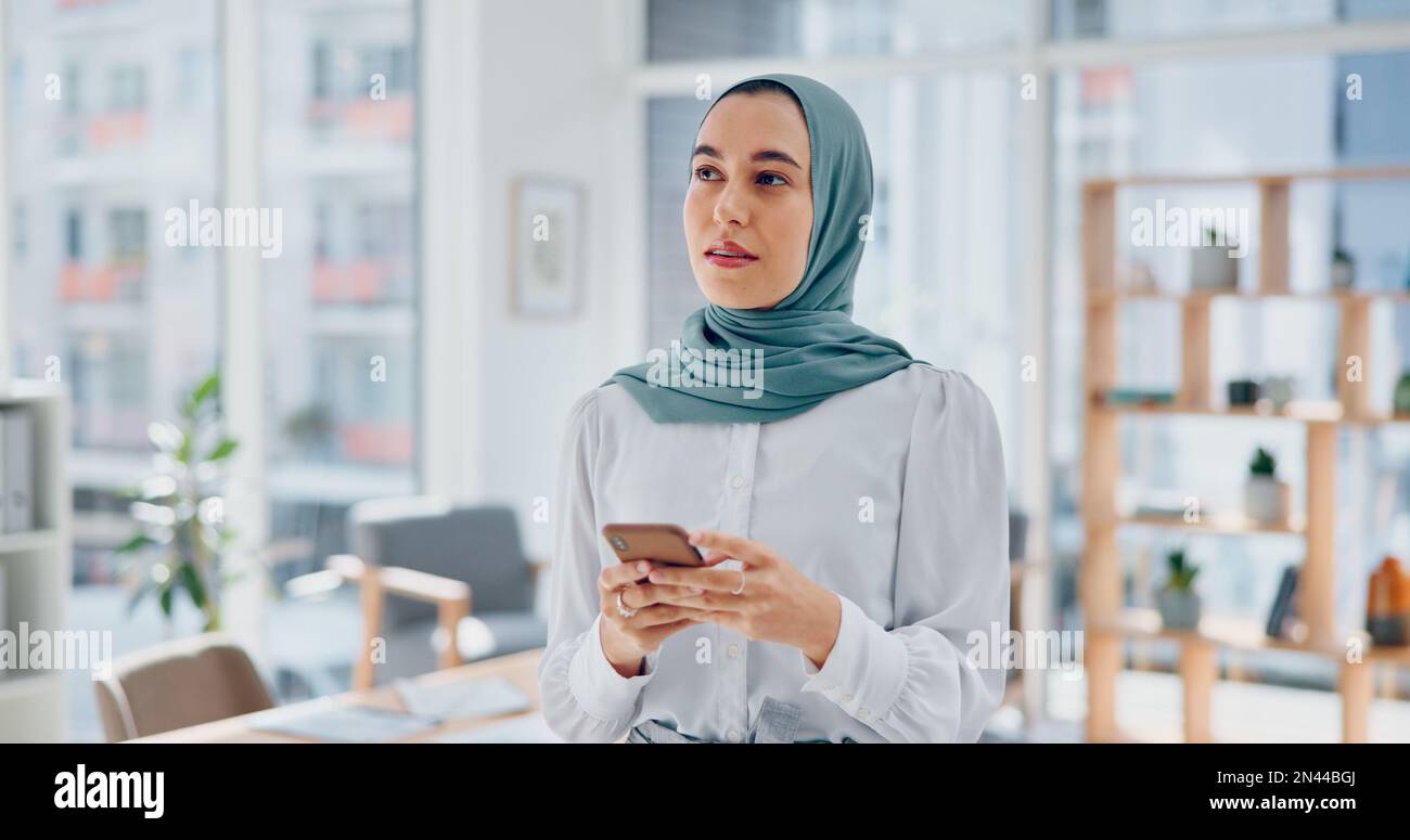 Phone, thinking and feedback with a business muslim woman typing a text ...