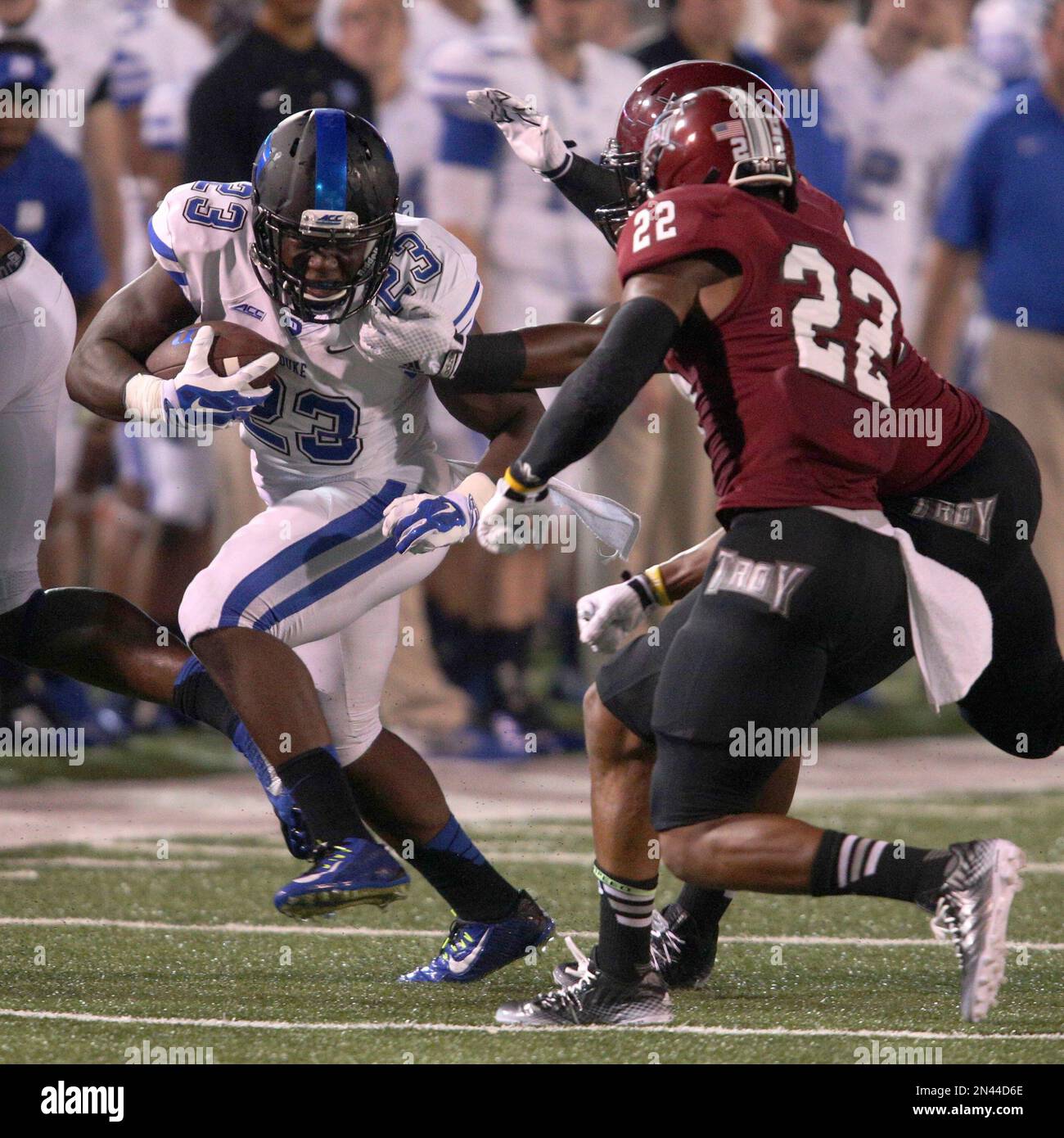 Duke running back Joseph Ajeigbe (23) tries to elude Troy safety Joe ...