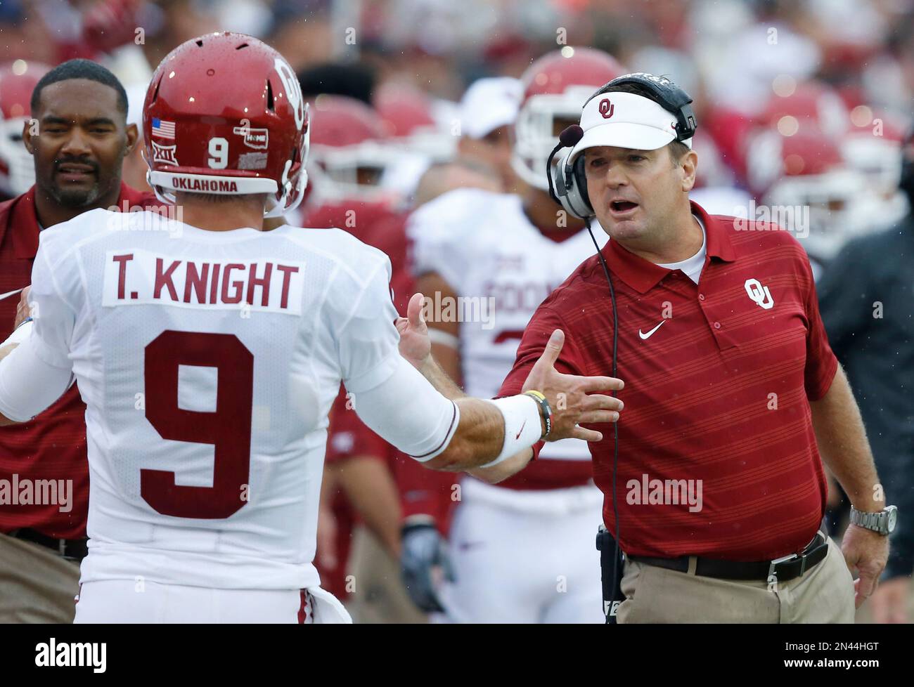 Oklahoma head coach Bob Stoops, right, greets quarterback Trevor Knight ...