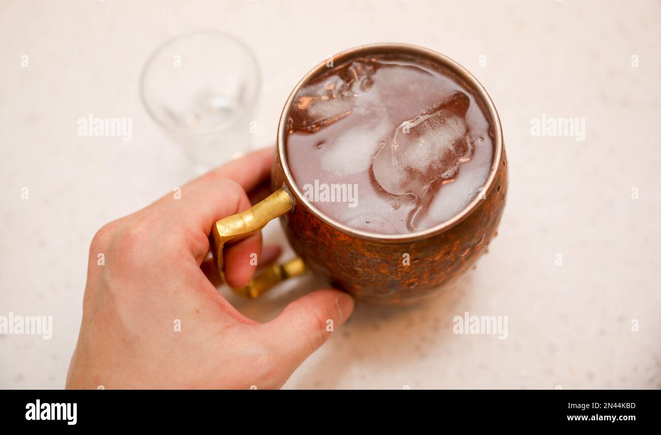Making alcohol drink with shot glass in cup Stock Photo - Alamy