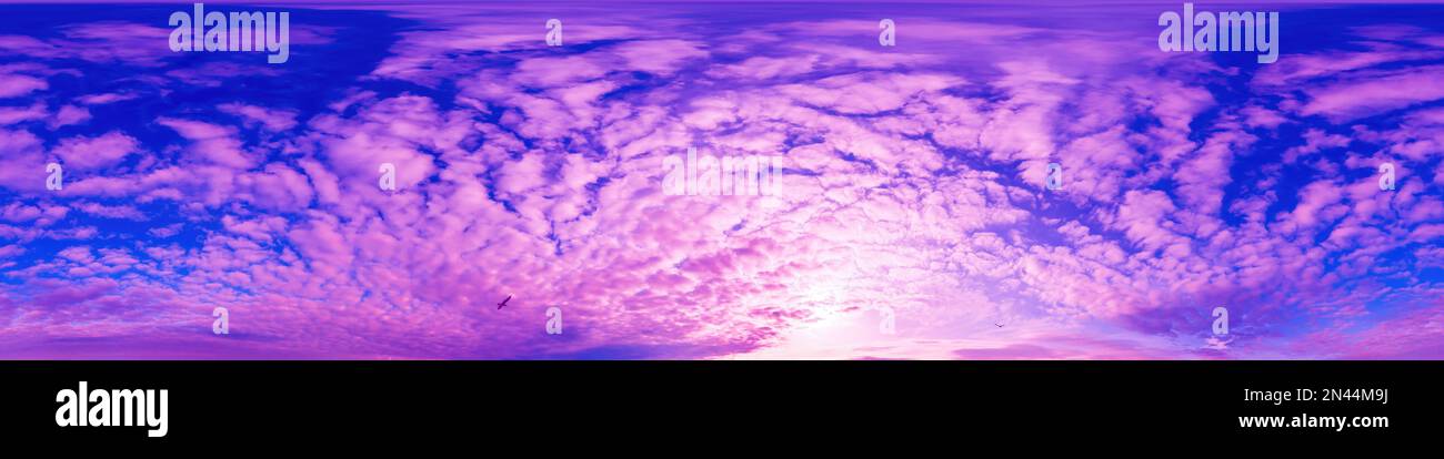 Panorama of a dark blue sunset sky with golden Cumulus clouds. Seamless ...