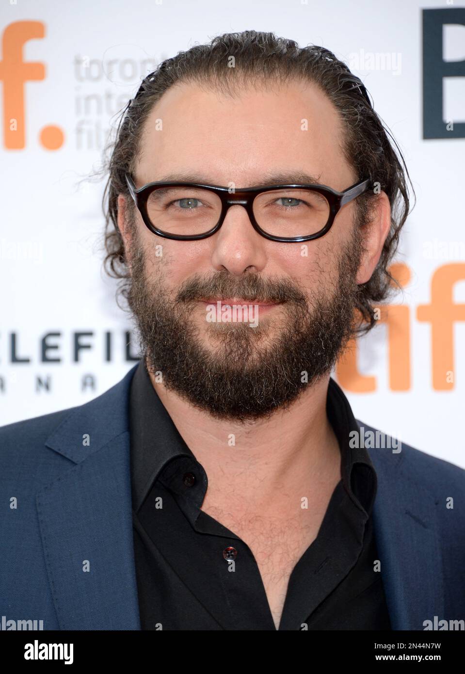 Director Michael R. Roskam arrives at the premiere of "The Drop" on day ...