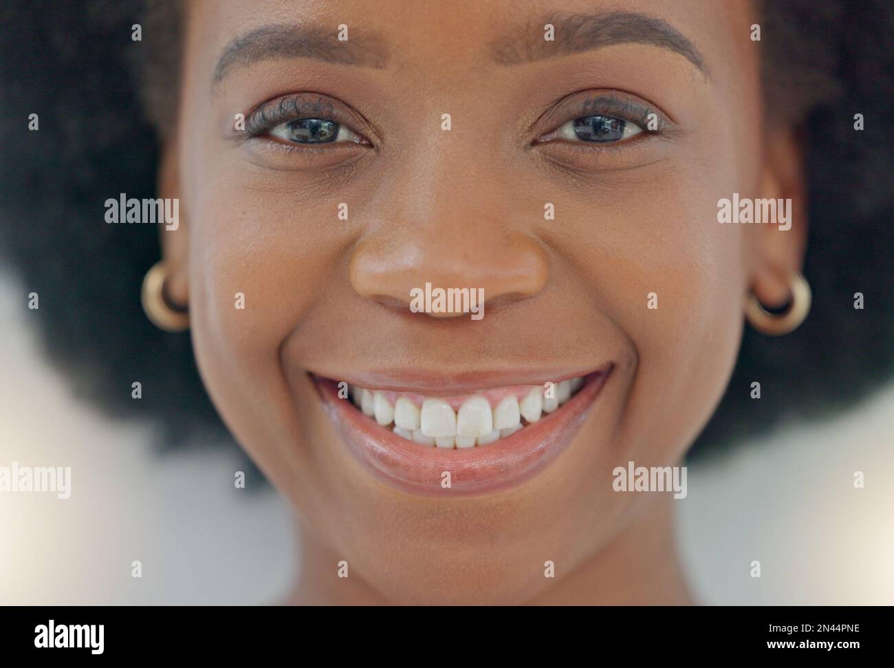 Face of an african american woman smiling and laughing with joy at the ...