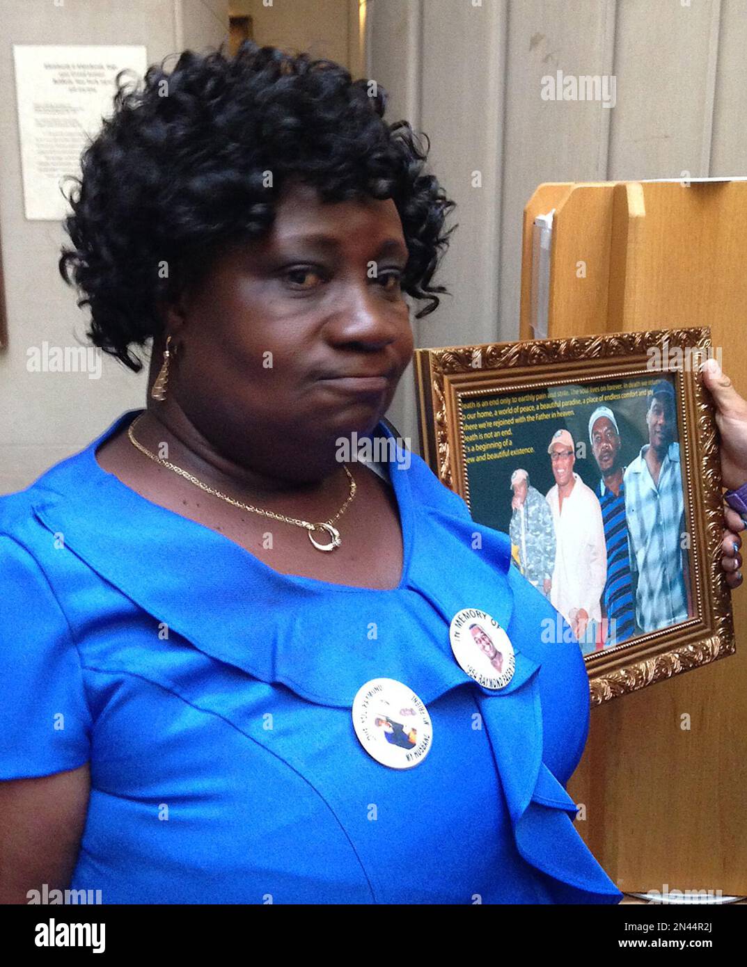 June Facey holds a photo showing her late husband, Raymond Facey, in ...