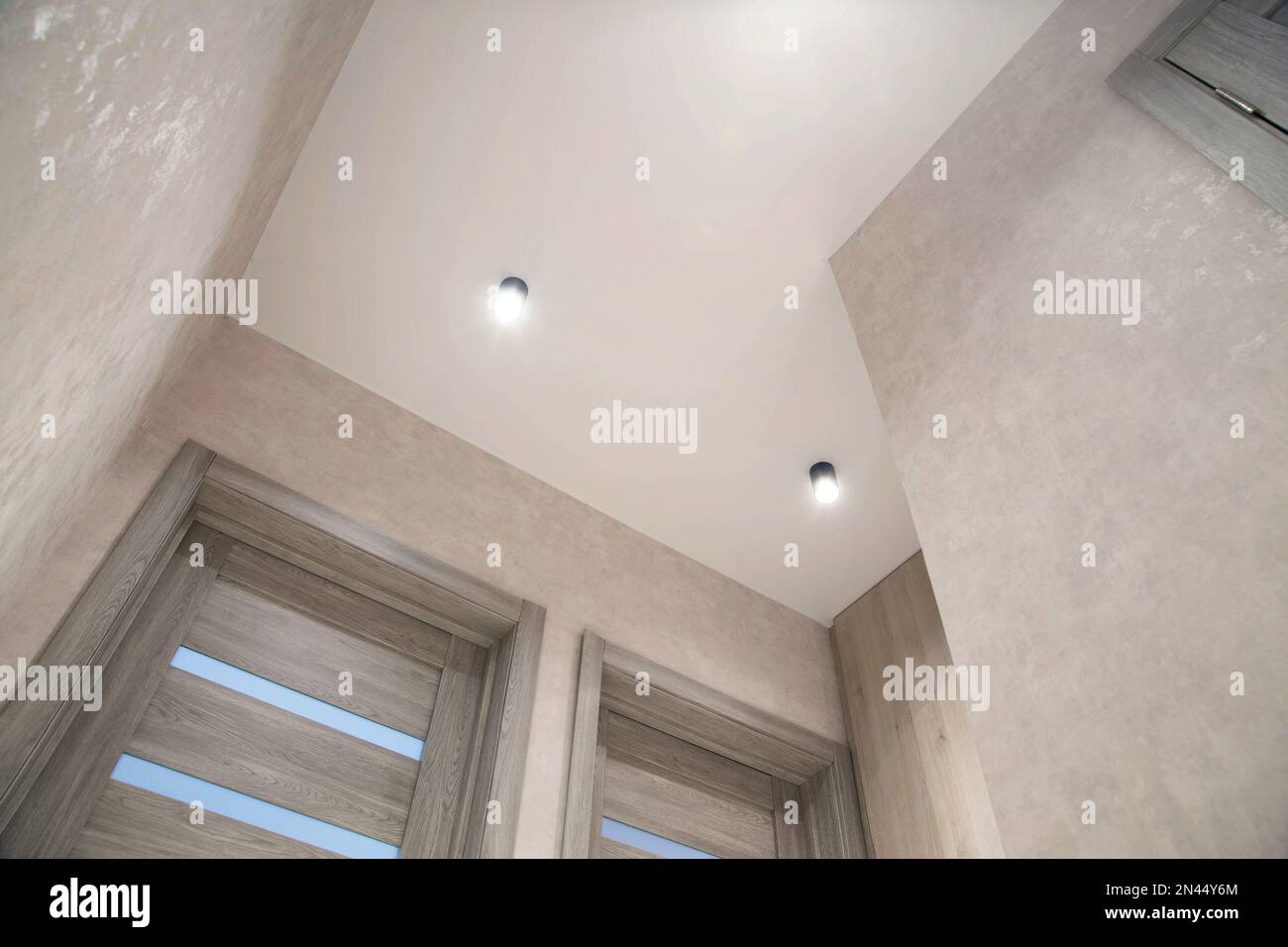 Modern renovation and design in the hallway. Black LED spotlights on ...