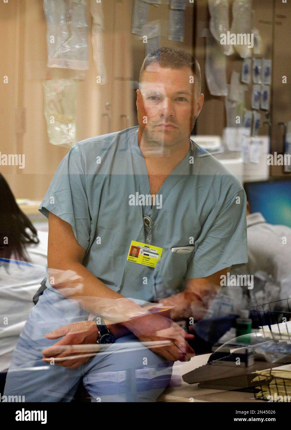 In this Aug. 6, 2014 photo, Dr. Jared Bernard, a lieutenant commander and trauma surgeon in the ...