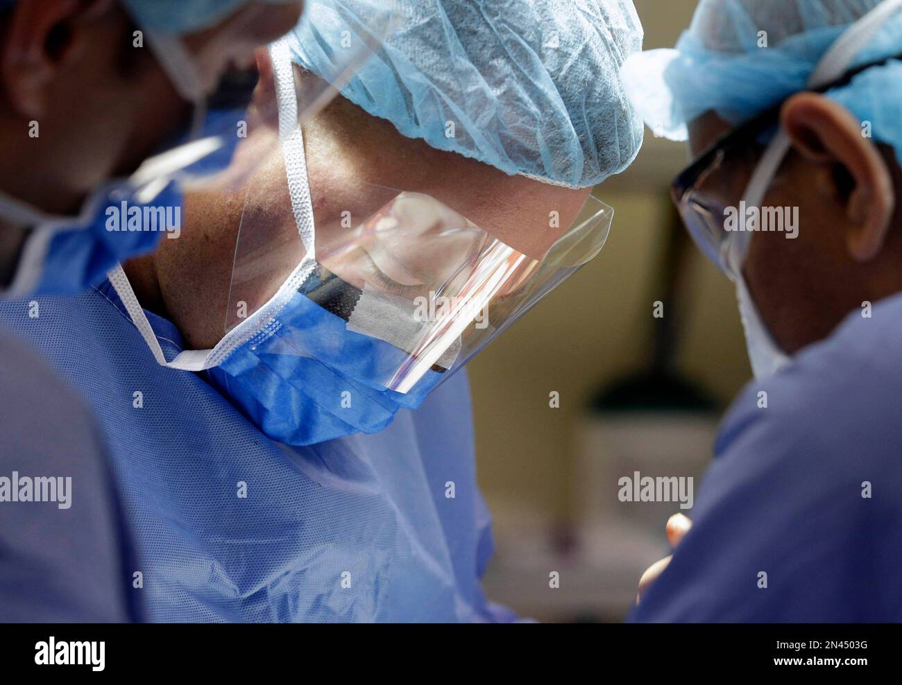 In this Aug. 6, 2014 photo, Dr. Jared Bernard, a lieutenant commander ...