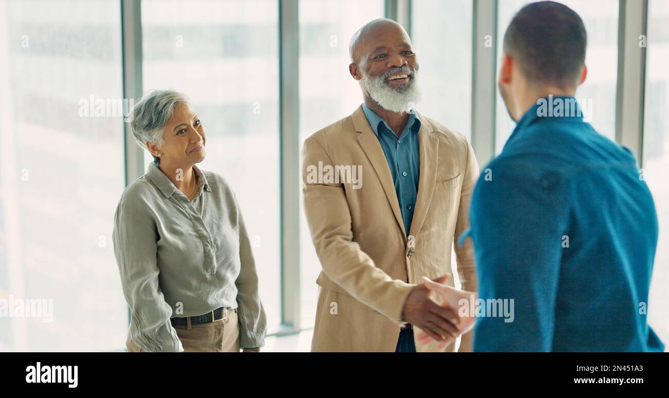 Handshake, welcome and thank you with business people in office after ...