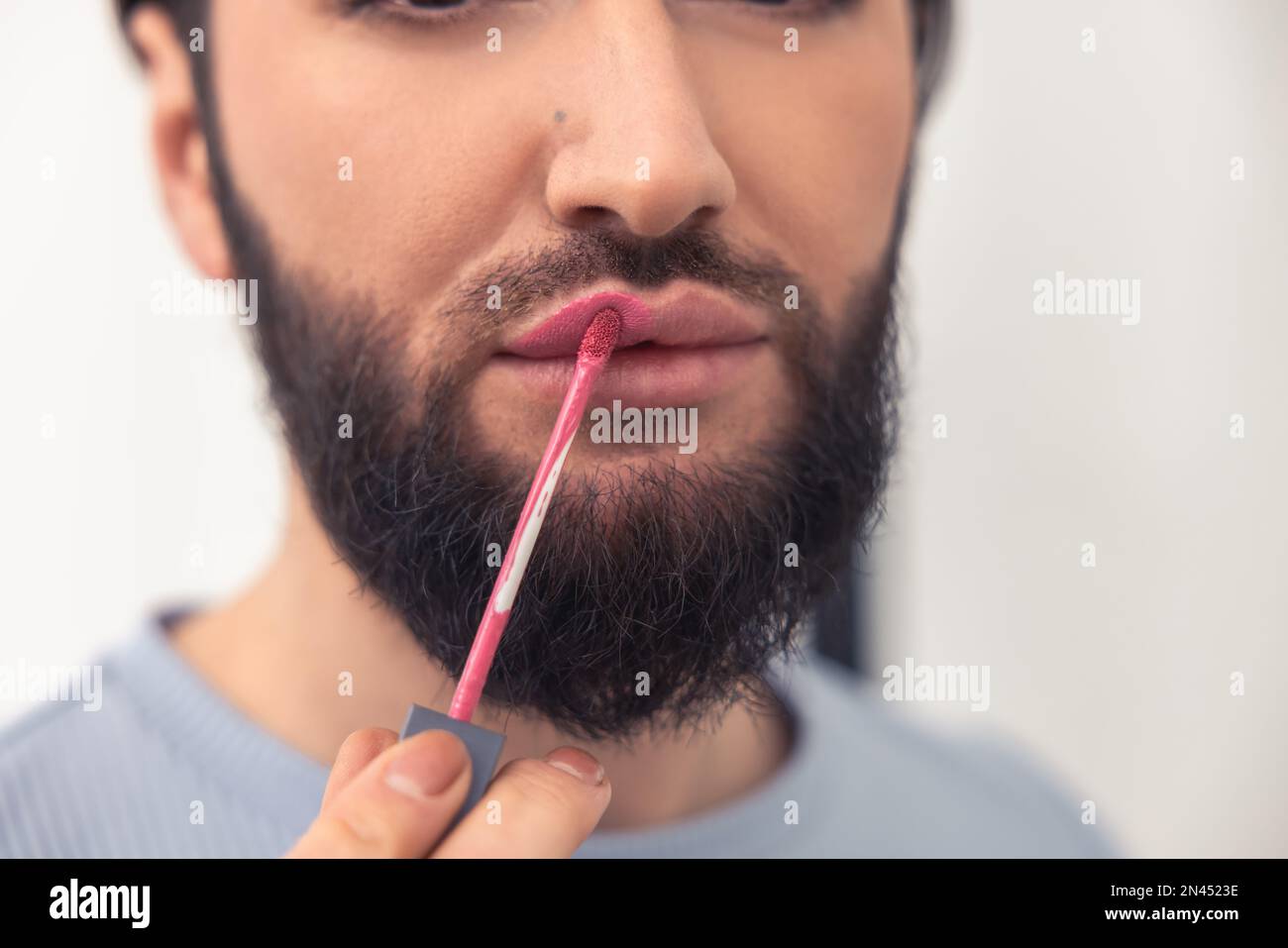 Transgender person focused on coloring his lips Stock Photo - Alamy