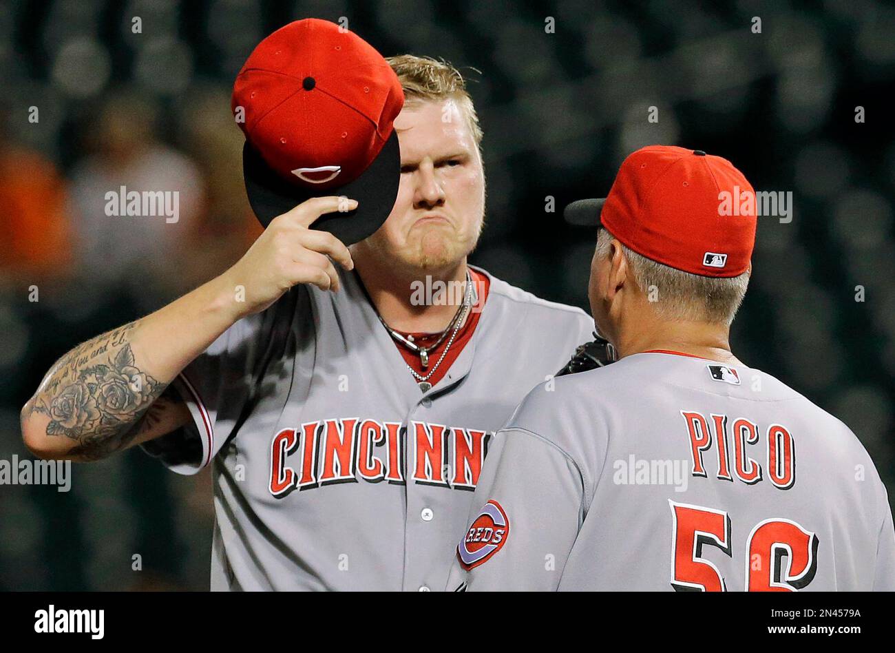 Cincinnati Reds starting pitcher Mat Latos, left, reacts as he speaks ...