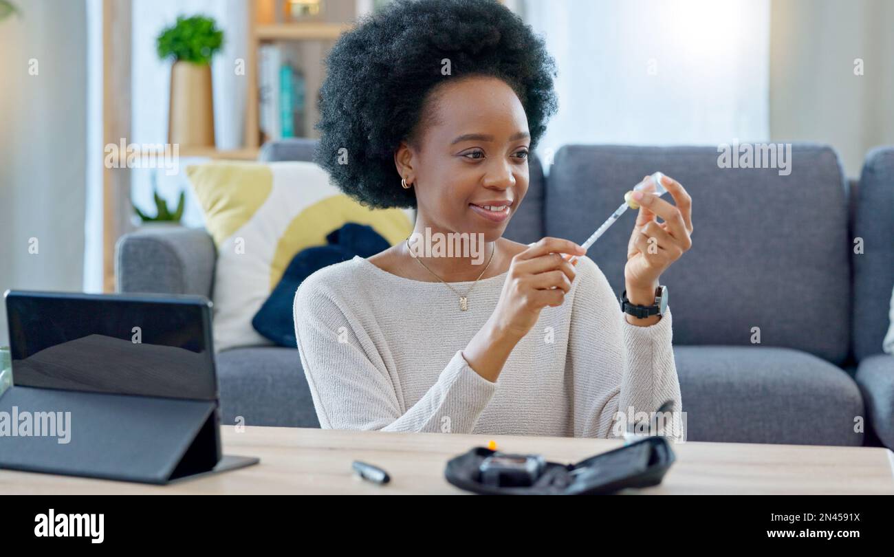 Woman with syringe preparing an insulin injection at home with an ...