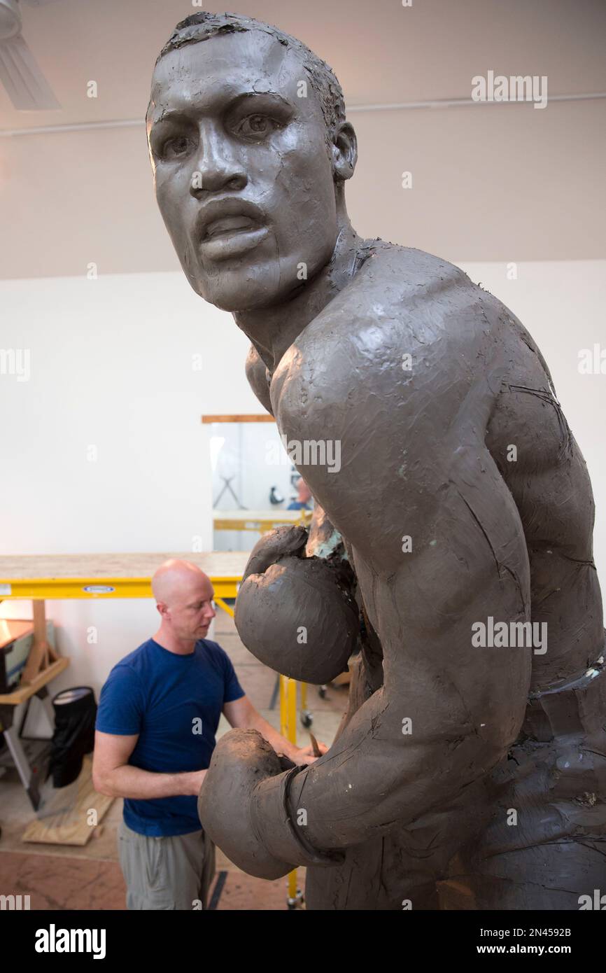 In this Aug. 14, 2014 photo, artist Stephen Layne works on a sculpture ...