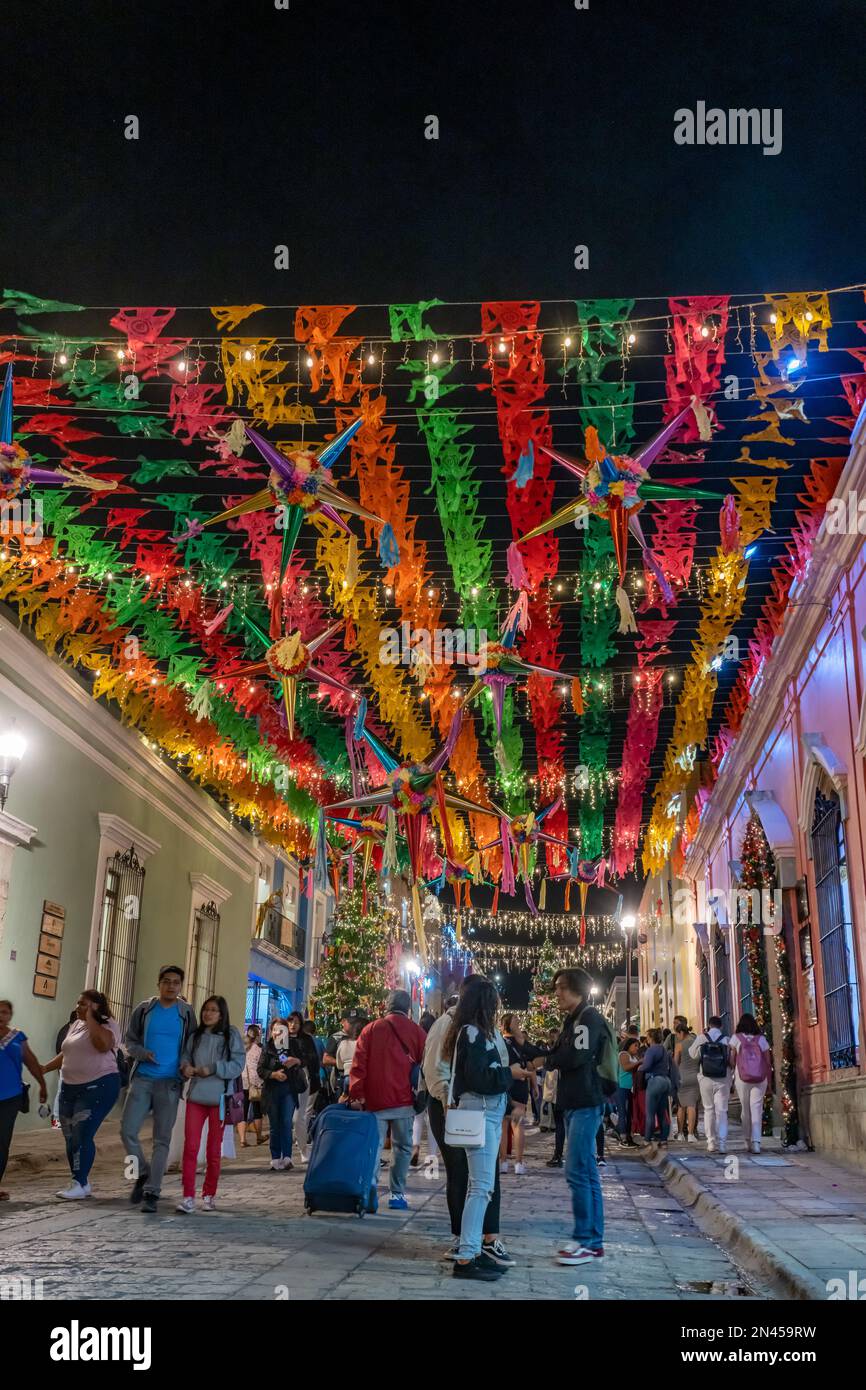 Crowds celebrate the Christmas season under the decorations on Calle ...