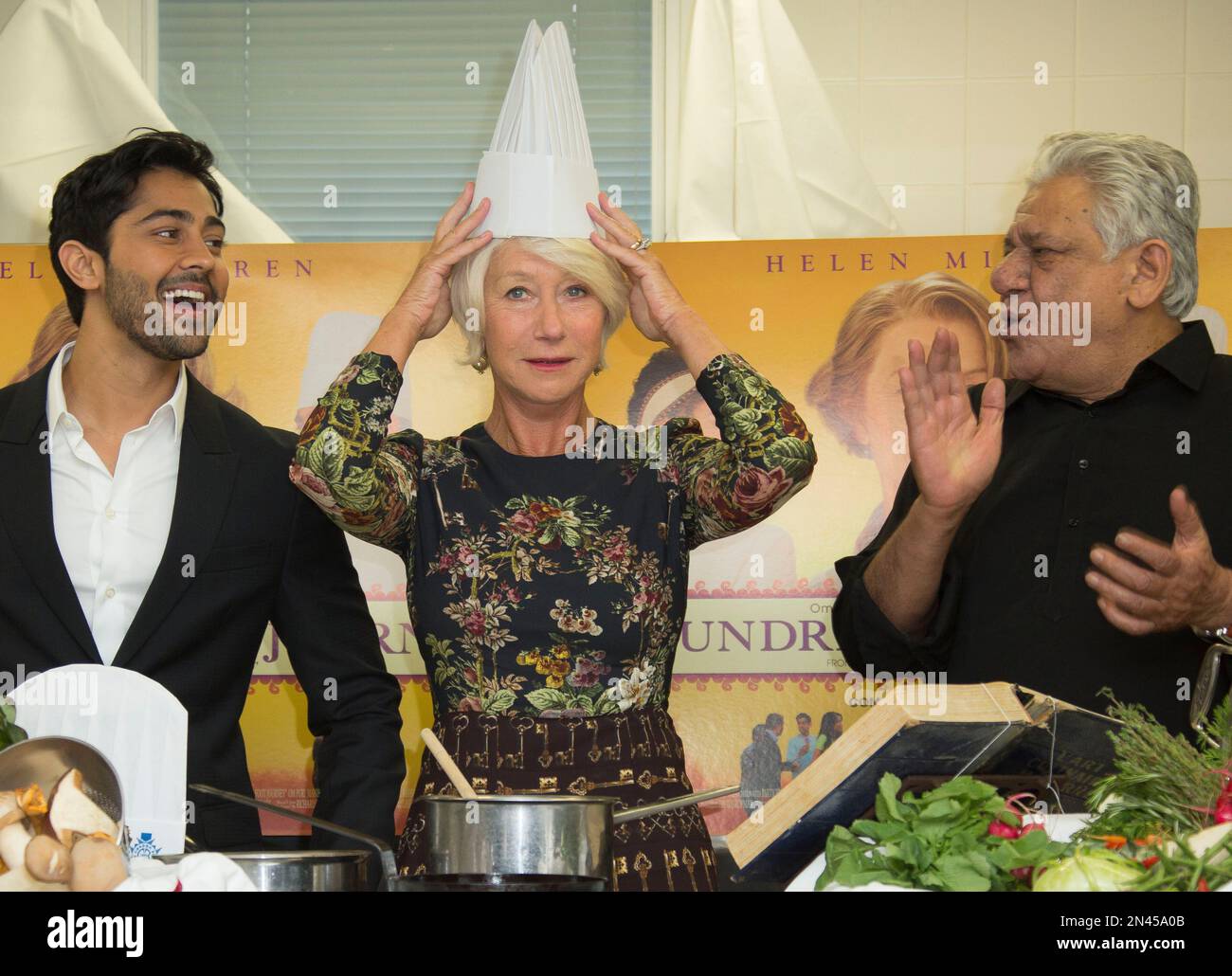 British actress Helen Mirren puts on a chef's hat as actors Om Puri ...