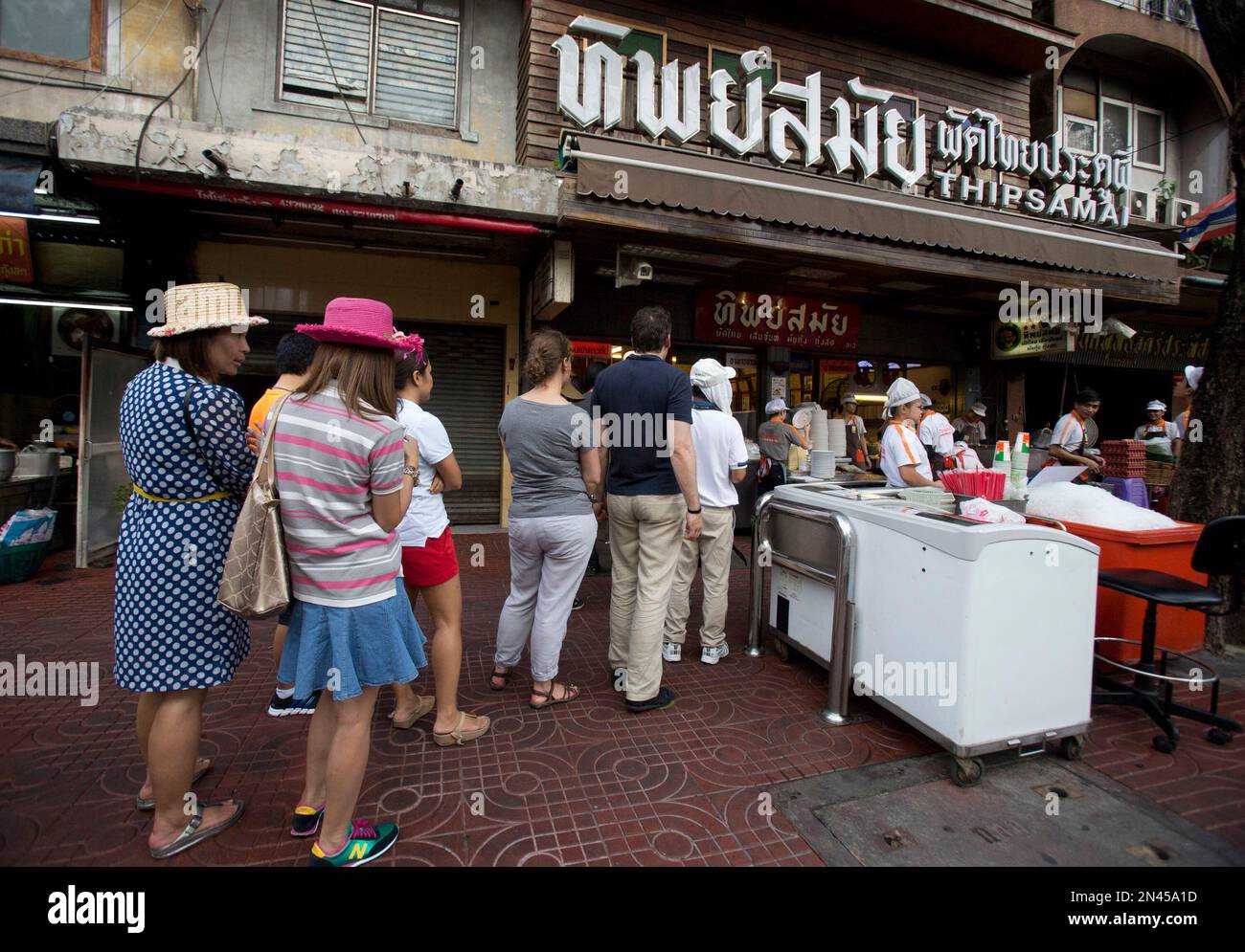 In this Wednesday, Aug. 13, 2014 photo, customers line up outside Thip ...