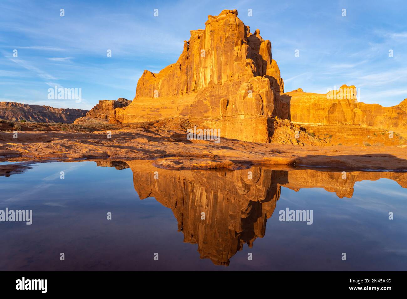 Entrada sandstone rock formation reflected in a rainwater pool in ...